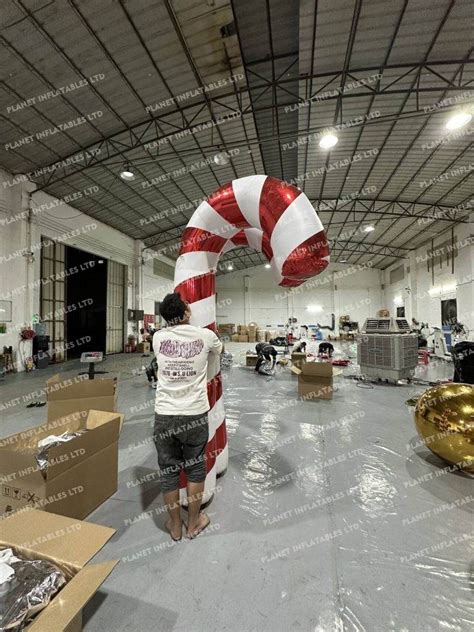 Welcome To A Playful Twist With Our Inflatable Candy Cane Planet Inflatables