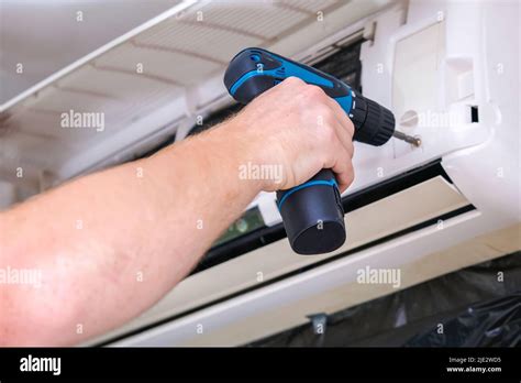 A Man Disassembles An Air Conditioner For Repair And Cleaning Split System Maintenance Stock