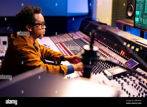African American Audio Engineer Mixing And Mastering Music With