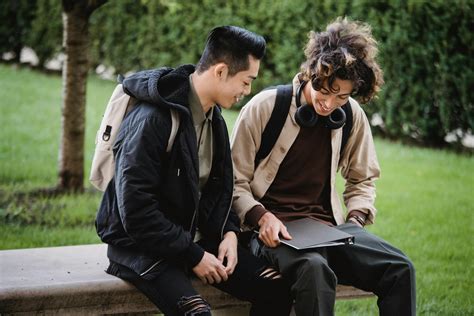 Positive Multiethnic Classmates Smiling Widely While Having