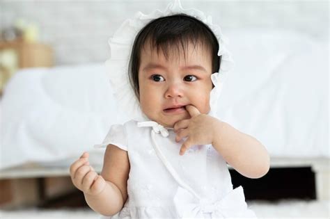 Premium Photo Cute Girl Looking Away While Sitting At Home