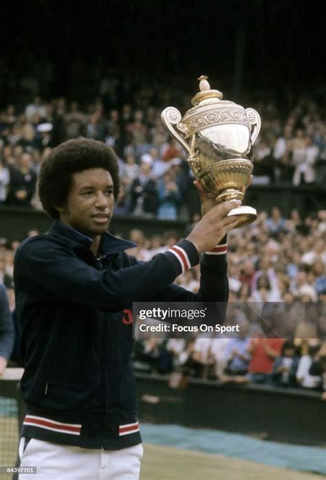 Arthur Ashe Of The Usa Holds Up The Championship Trophy For Mens