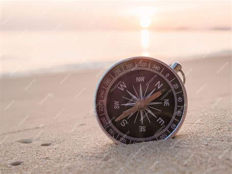 Premium Photo Close Up Compass On The Beach With Sunlight