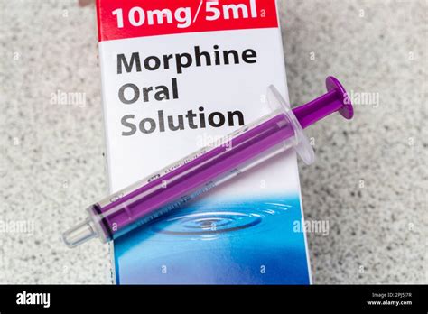 A Close Up Of A Box Of Morphine Oral Solution With A Oral Syringe Stock
