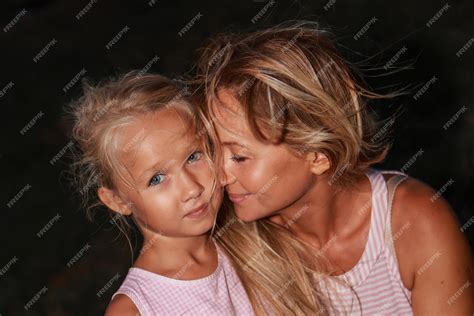Premium Photo Happy Mom And Daughter Are Hugging In The Evening On