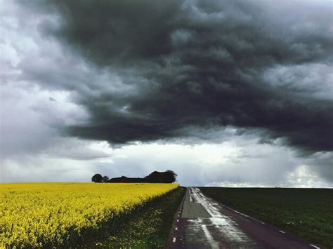 Premium Photo Road Passing Through Field