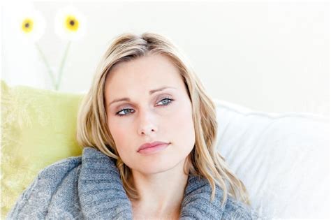 Premium Photo Exhausted Woman Lying On The Sofa With A Grey Pullover Against Frost