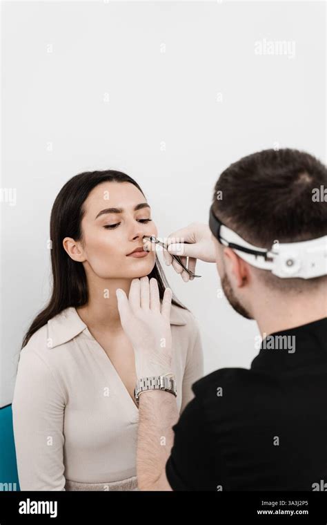 Otolaryngologist Examines Girl Nose Before Procedure Of Endoscopy Of