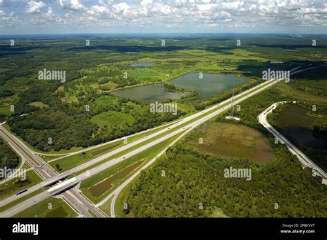 Aerial View Of Freeway Overpass Junction With Fast Moving Traffic Cars And Trucks Interstate