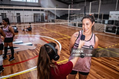 Young Woman Tv Reporter Interviewing Female Volleyball Player On The