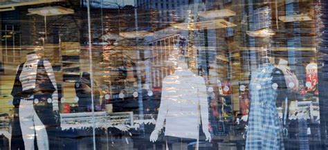 This Image Is Of A Clothes Shop Window In The Center Of Town With A
