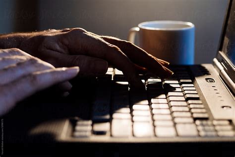 Man Working Late On A Computer By Stocksy Contributor Harald Walker