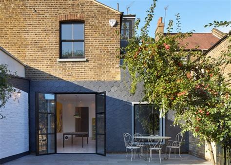Slate House Is An Extension Clad With Hexagonal Tiles