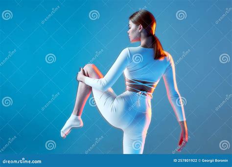 Beautiful Flexible Girl Standing Back With Her Knee Up Isolated Figure Of Sporty Girl In White