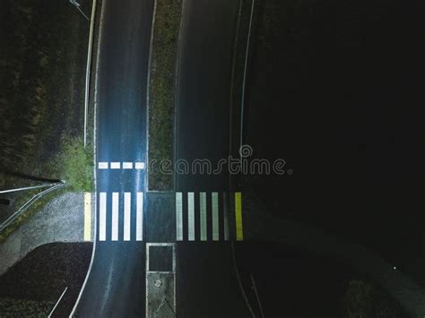 Aerial View Of A Pedestrian Crossing Illuminated By Streetlamps At