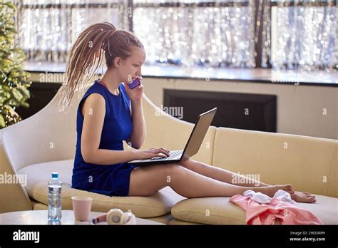 Live Streaming Classes By Woman With Handy And Laptop Indoors Stock