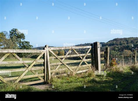 Wooden Gate Across A Grassy Meadow In The Countryside Captured On A