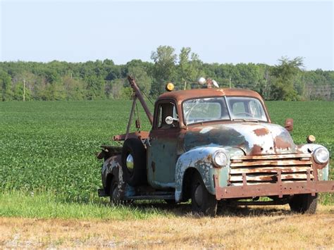 Premium Photo Old Rusty Tow Truck On Grassy Field Against Clear Sky