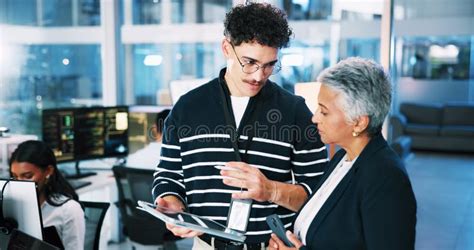 Developer Tablet And Advice With Woman In Office For Software System Or Website Update Night