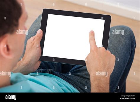 Closeup Of Mid Adult Man Looking At Blank Screen Of Digital Tablet At Home Stock Photo Alamy