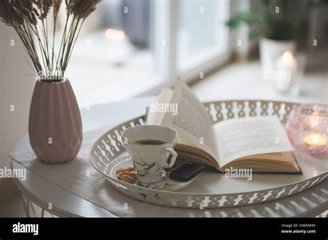 Photo Of Stylish White Tray With Black Koffee And Dark Chocoltte And A Book Cozy Chair On