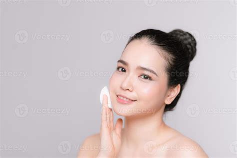 Smiling Pretty Young Woman Cleaning Her Face Using Cotton Pads And