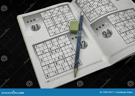 Sudoku Game In Magazine On A Black Background Games To Exercise The Brain Editorial Photo