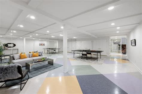 Modern Basement Interior Featuring A Ping Pong Table And Cozy Seating