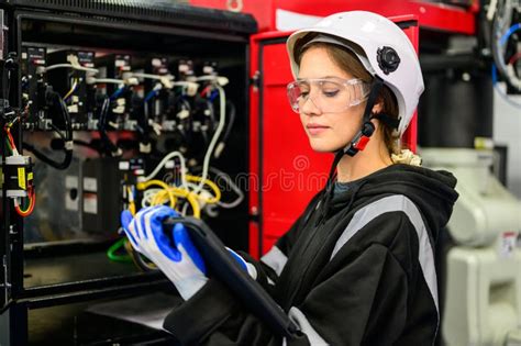 Young Technician Checking And Repairing Part Of Automatic Machine Stock