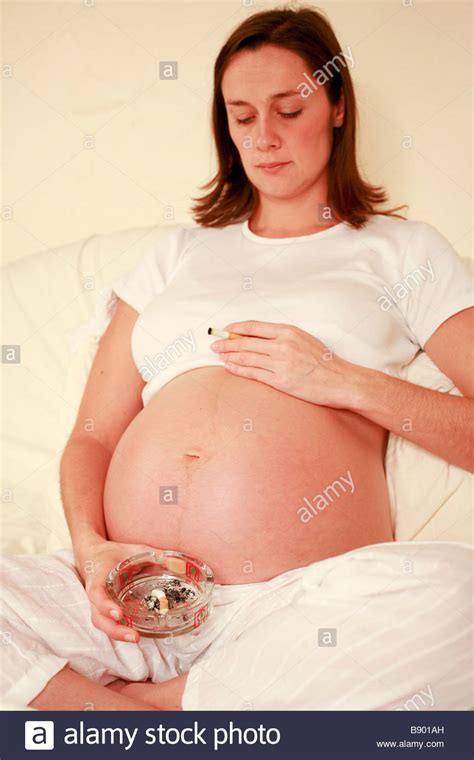 Young Heavily Pregnant Woman Relaxes With Crossed Legged At Home And