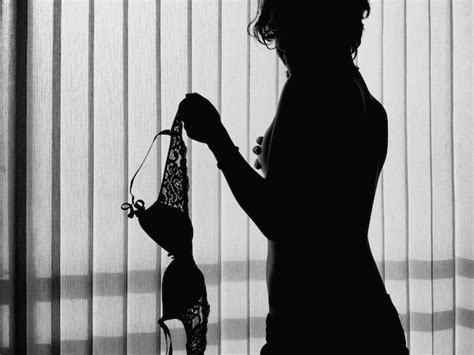 Premium Photo Silhouette Sensuous Shirtless Woman Holding Bra While