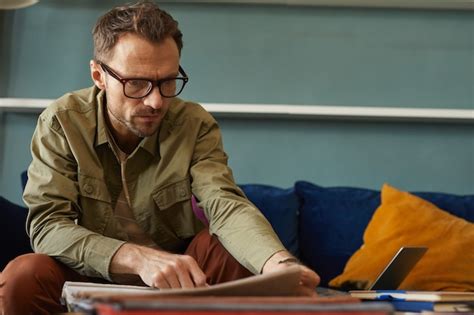 Premium Photo Serious Designer In Eyeglasses Sitting At The Table And