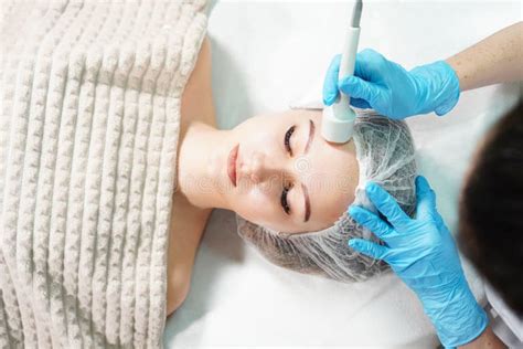 Microcurrent Therapy For Facial Care Cosmetologist Doing Face