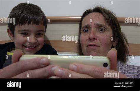 Scared Mother Watches On Smartphone Something With Horror And Her Son With I Stock Video Footage