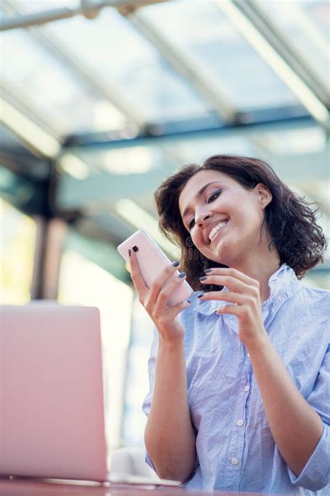 Portrait Of A Playful Young Girl Taking Selfie With Mobile Phone While