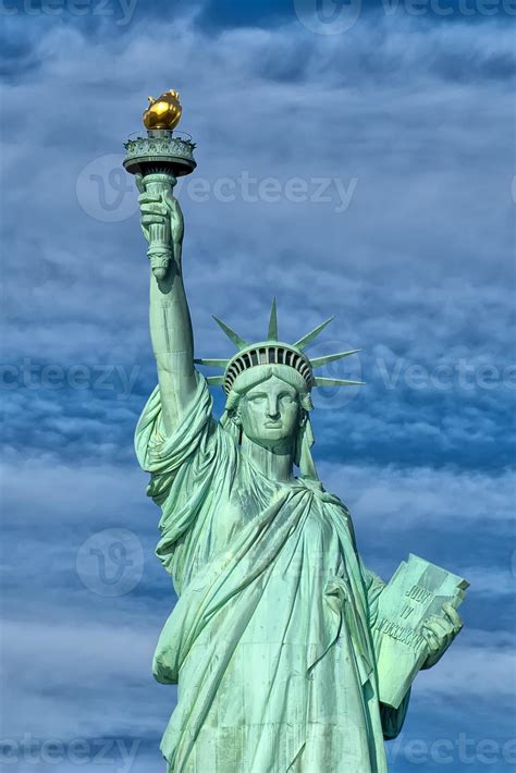 Statue Of Liberty Close Up Vertical Isolated In Blue Cloudy Background