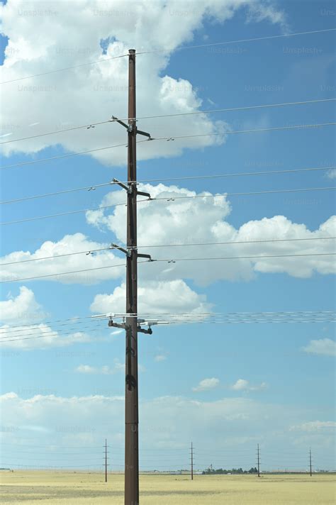 A Telephone Pole With Multiple Wires And A Sky Background Photo