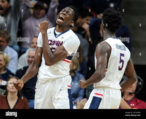 Connecticuts Amida Brimah Left And Daniel Hamilton Right React