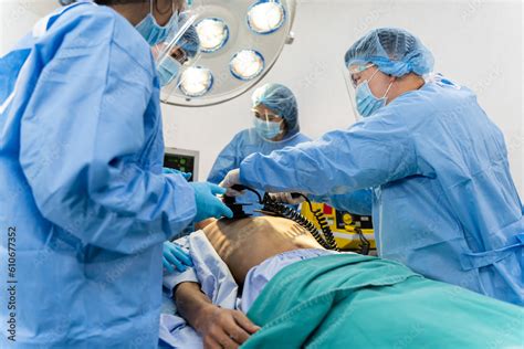 Medical Team In Surgical Gown Help Patient To Making Cpr Cardio