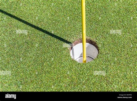 Golf Course Putting Green Closeup Detail Grass Flagstick And Hole Stock