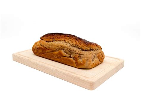Premium Photo Close Up Of Bread On Cutting Board Against White Background