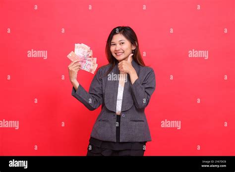 Indonesia Office Woman Smiling Holding Credit Debit Card And Money While Giving A Thumbs Up