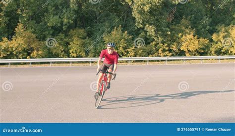 Professional Biker Raising His Arms Celebrating Winning Of Race Stock