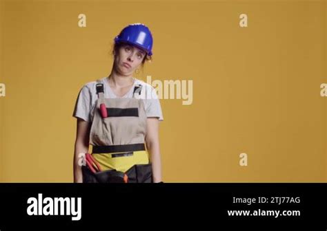 Portrait Of Female Builder Being Hit In Head And Feeling Dizzy Seeing