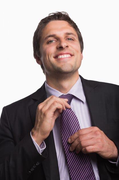 Premium Photo Portrait Of A Happy Businessman Adjusting Tie