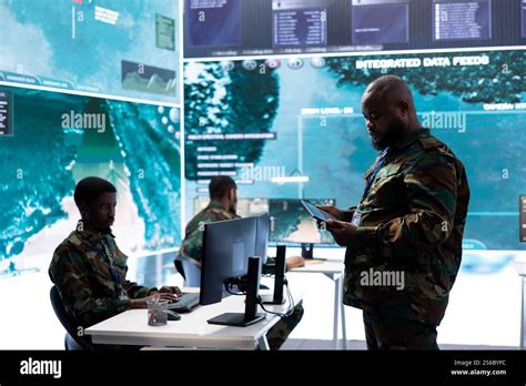 Military Personnel In A High Tech Control Room Work On Data Integration