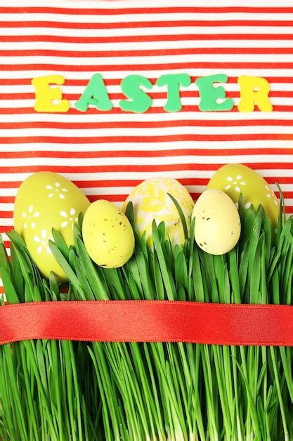 Premium Photo Easter Eggs And Grass On Colorful Paper Background
