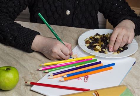 Girl Doing Homework And Eating Dried Fruits Stock Image Image Of