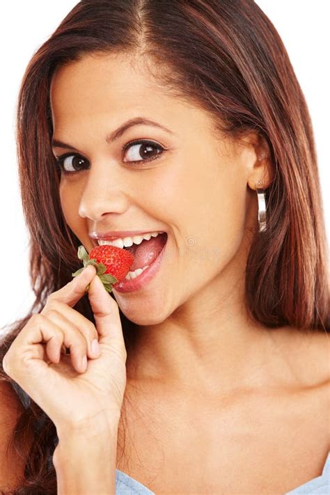 Mmmmfruity Freshness A Beautiful Young Ethnic Woman Taking A Bite Of A Fresh Strawberry