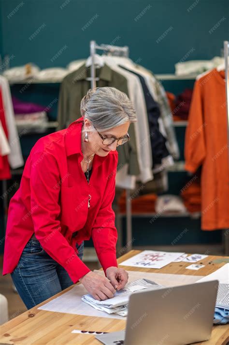 Premium Photo Woman Carefully Packing Clothes Bent Over Table